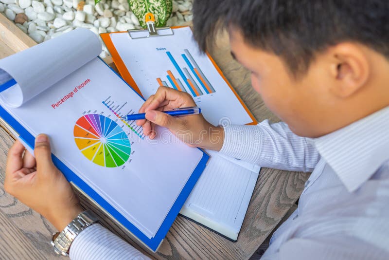Asian Financial Executive Analyzing Data in Pie Chart Document Stock ... Asian Financial Executive Analyzing Data in Pie Chart Document Stock ...