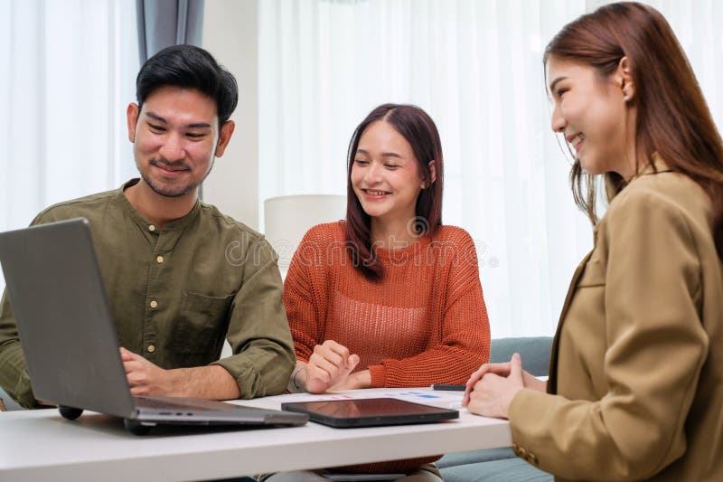Asian Financial Advisor Presenting Charts and Data on a Tablet during ...