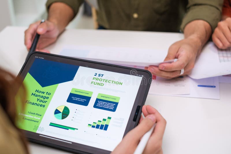 Asian Financial Advisor Presenting Charts and Data on a Tablet during ...