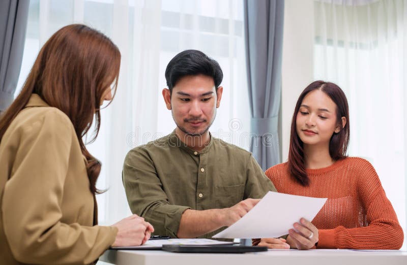 Asian Financial Advisor Presenting Charts and Data on a Tablet during ...