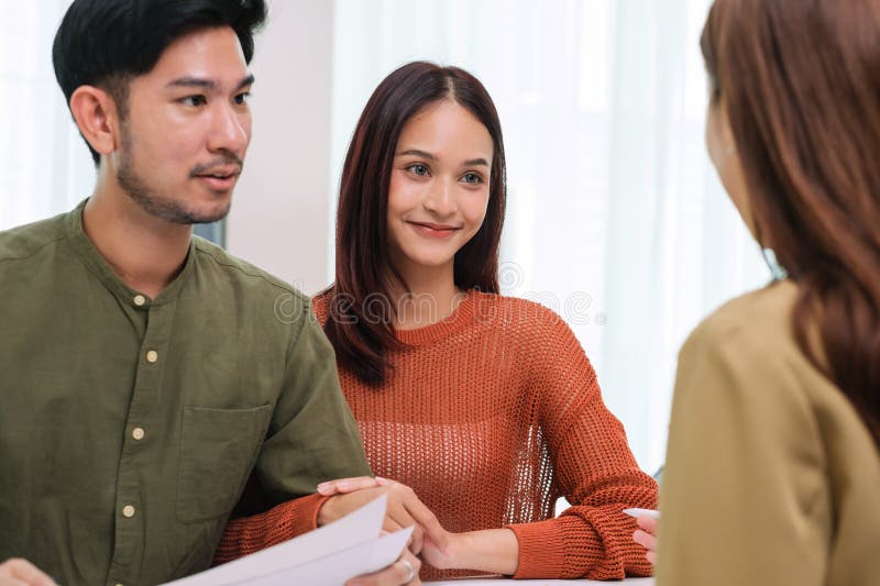 Asian Financial Advisor Presenting Charts and Data on a Tablet during ...
