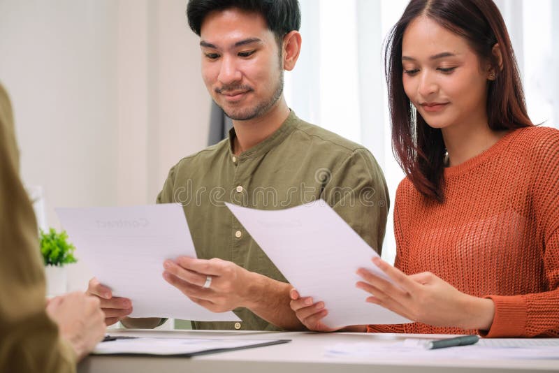 Asian Financial Advisor Presenting Charts and Data on a Tablet during ...