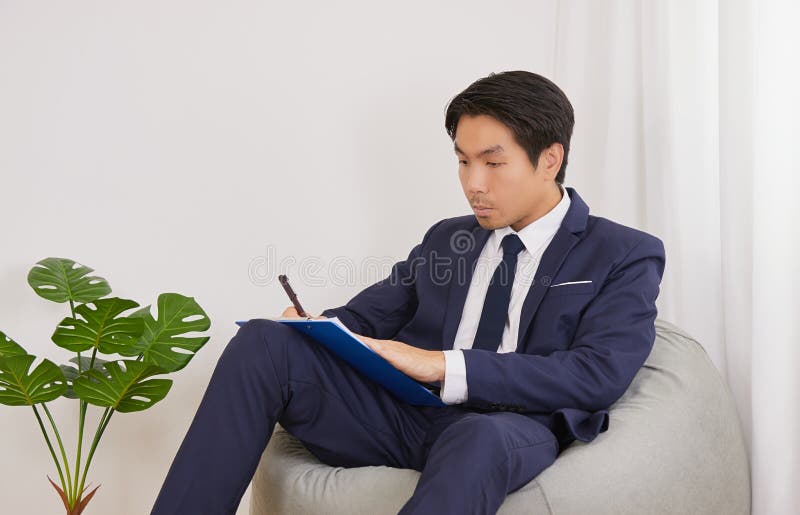 Asian Financial Advisor Write Statements in Clipboard Stock Photo ... Asian Financial Advisor Write Statements in Clipboard Stock Photo ...