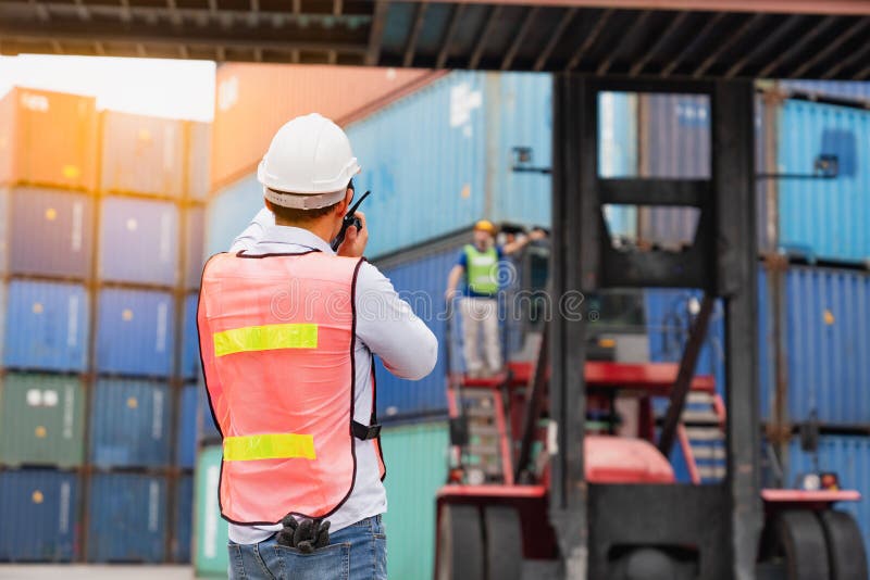 Two Logistic Staff Workers Talk and Rest Sitting in the Shipping Yard ...