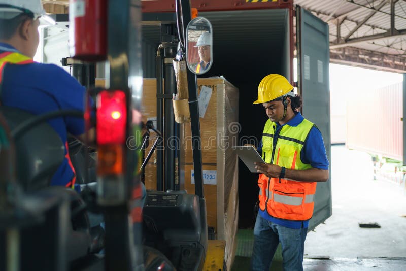 Asian Forklift Driver Loading a Shipping Cargo Container with a Full ...