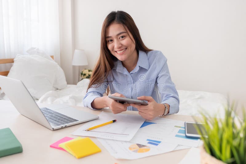 Asian Freelancer Looking at Camera and Holding Tablet while Work Stock ...