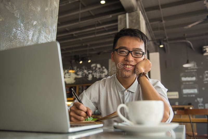 Asian Freelancer Smiling and Working in the Cafe Stock Image - Image of ...