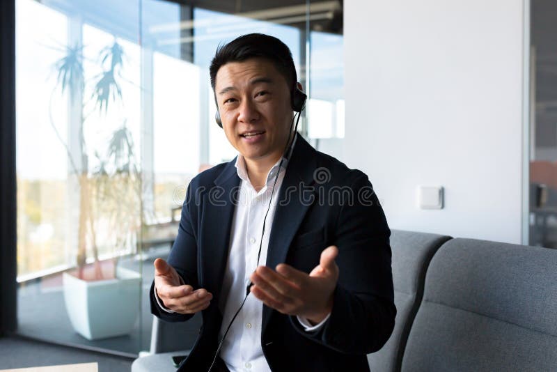 Asian Friendly Looking at Webcam and Talking, Businessman with Headset ...
