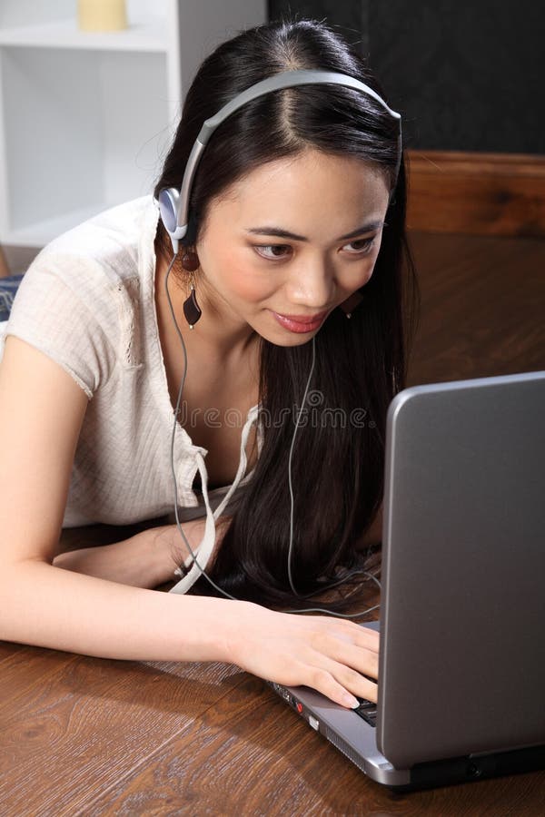 Asian Girl with Headphones Using Skype on Laptop Stock Image - Image of ...