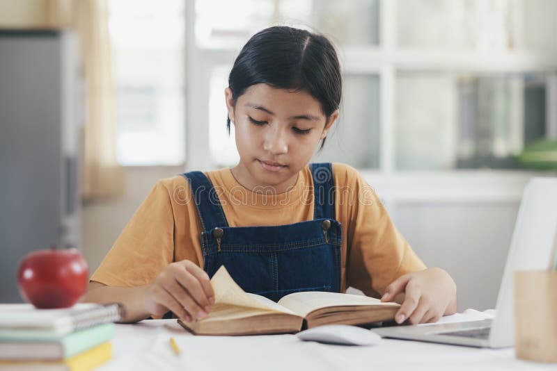 Asian Girl Reading and Doing Homework at Her Home Stock Photo - Image ...