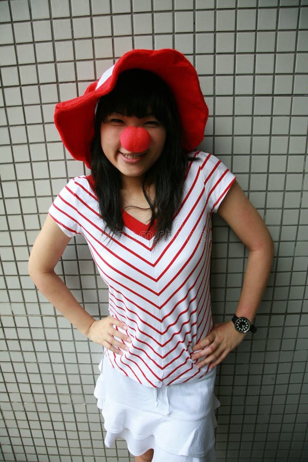 Asian Girl with Red Nose and Hat Stock Image - Image of smile, daylight ...