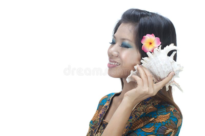 Asian girl with sea shell stock photo. Image of balinese - 27333438