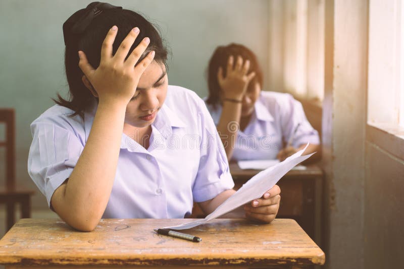 Asian Girl Student Reading and Writing Exam with Stress Stock Photo ...