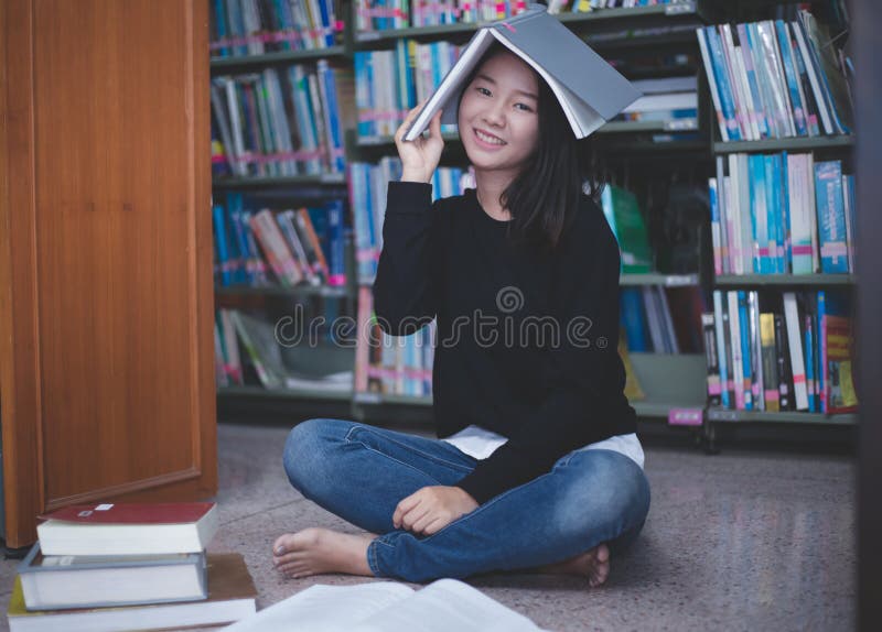 Asian Girl Students Reading Books and Using Notebook in the Library ...