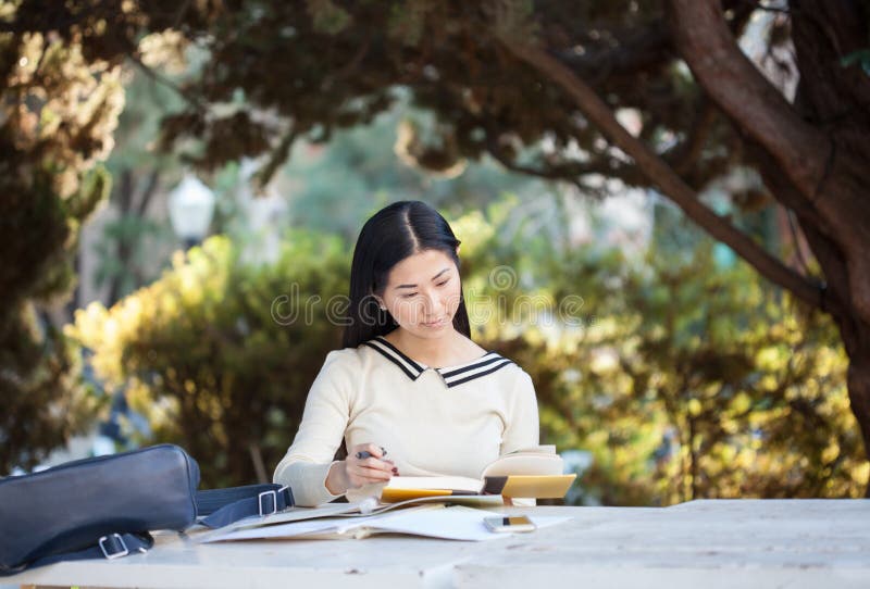 Beautiful Asian Girl Reading a Book in the Park Stock Photo - Image of ...