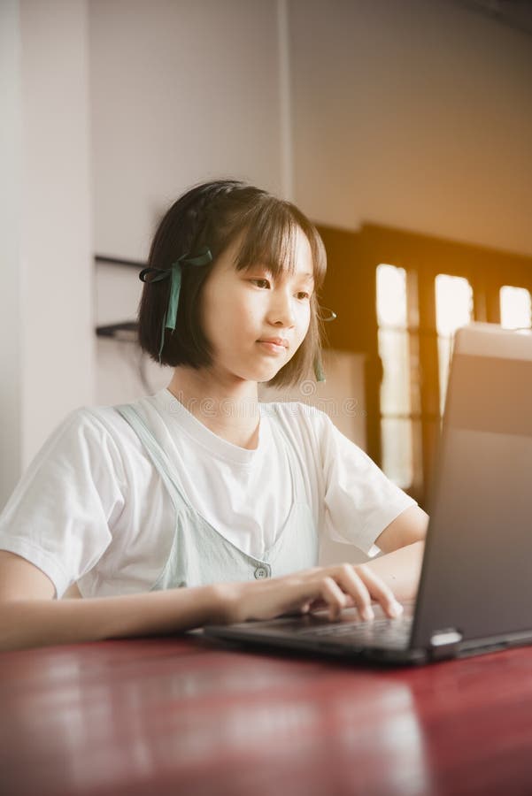 An Asian Girl is Using a Laptop Computer To Study Online. Stock Image ...