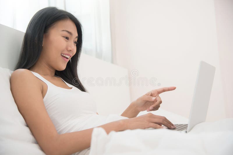 Asian girl using on laptop stock photo. Image of happiness - 99956384