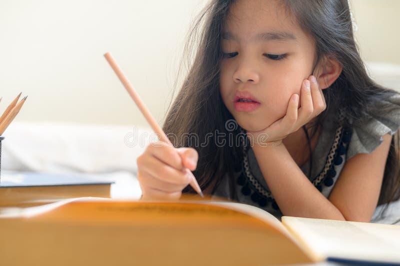 Asian Girl Writing with Pencil and Notebook Stock Photo - Image of ...