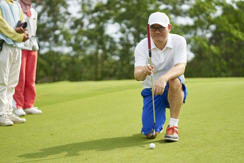 Golfer Crouching on Golf Course Stock Image - Image of black, balance ...
