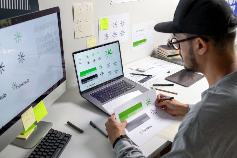 Graphic Designer Making Notes on Logo Designs, Designing Logos, and ...