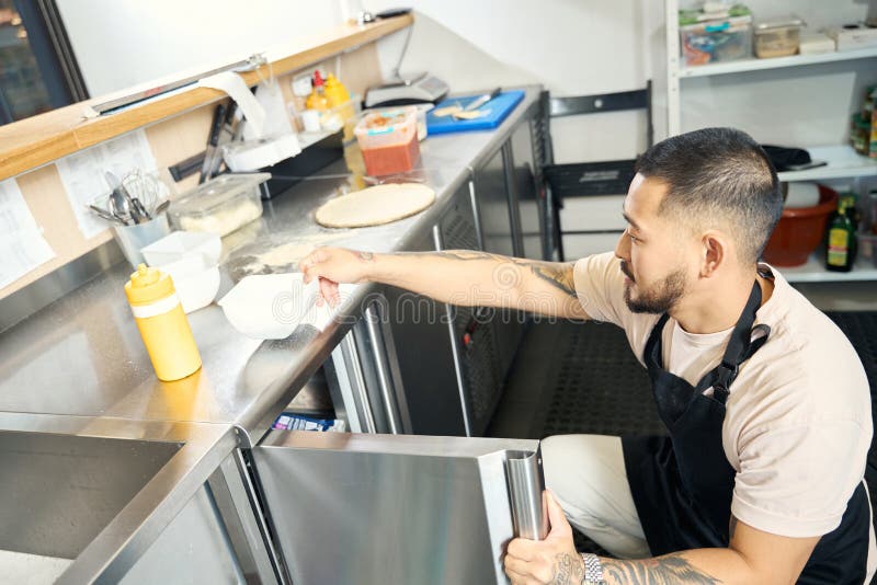 Asian Guy in Apron Preparing His Kitchen for a Cook-off Stock Photo ...