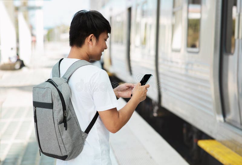 Asian Guy Student Using Smartphone, Standing by Train Stock Image ...