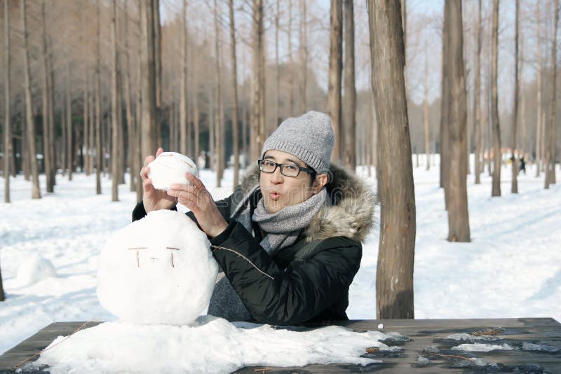 Asian Handsome Guy Building Snowman in Garden Stock Photo - Image of ...