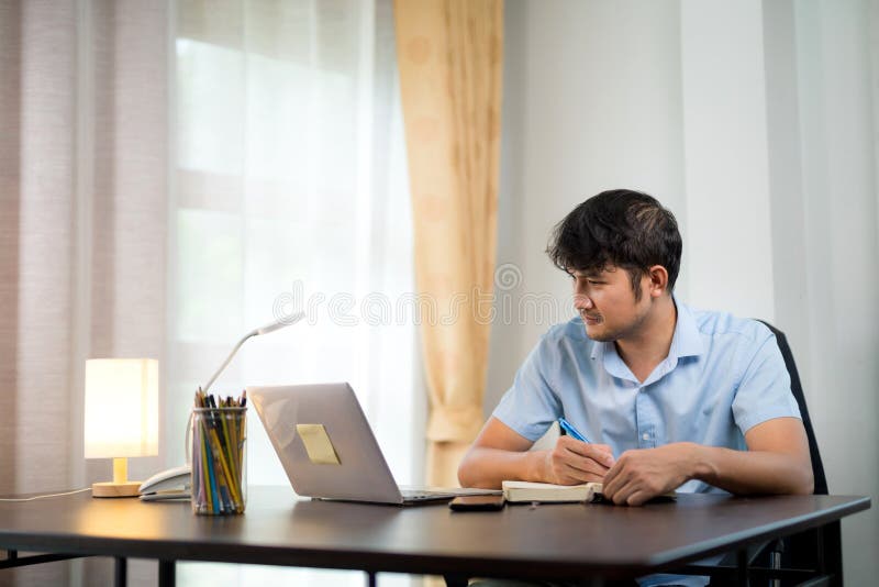 Asian Handsome Man Taking Notes while Learning Online Video Conference ...