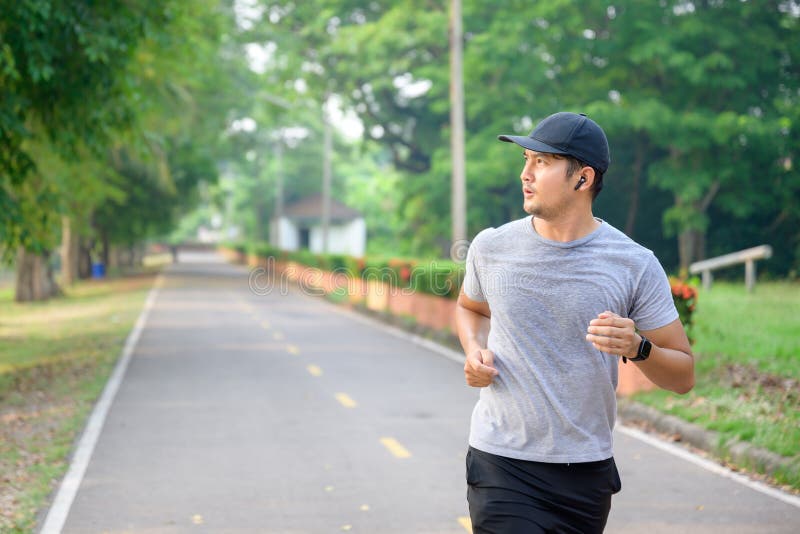 Asian Handsome Young Man Doing Exercise by Running in the Park Sweating ...