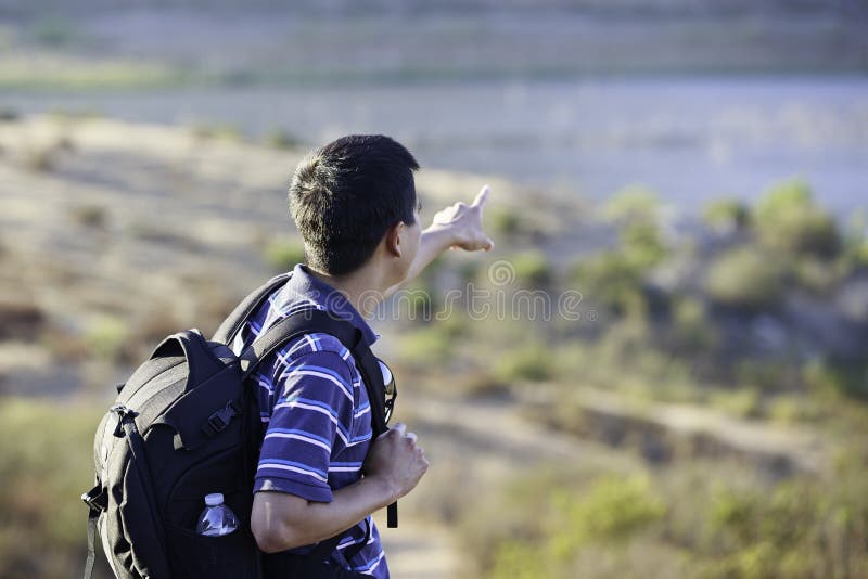 Asian Hiker Pointing at a Lake Stock Photo - Image of asian, grass ...