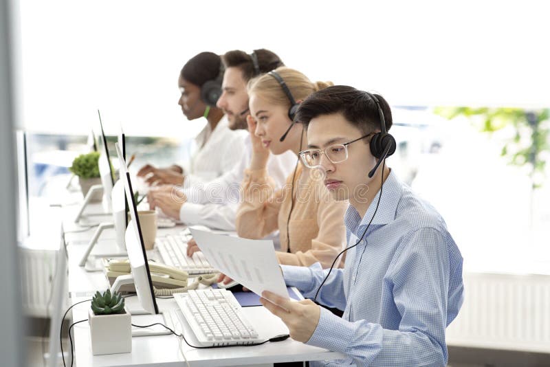 Asian Hotline Operator Working with Documents, Providing Technical ...