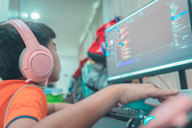 Asian Kid Coding and Scripting Program on on His Game Streaming Desktop ...