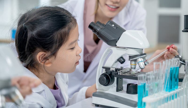 Asian Kid Learning with Scientist in the Laboratory. Physical ...
