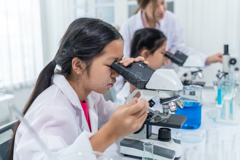 Asian Kid Learning with Scientist in the Laboratory. Physical ...