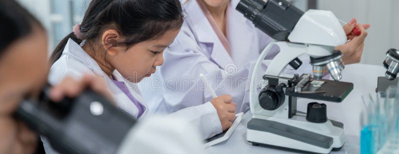 Asian Kid Learning with Scientist in the Laboratory. Physical ...