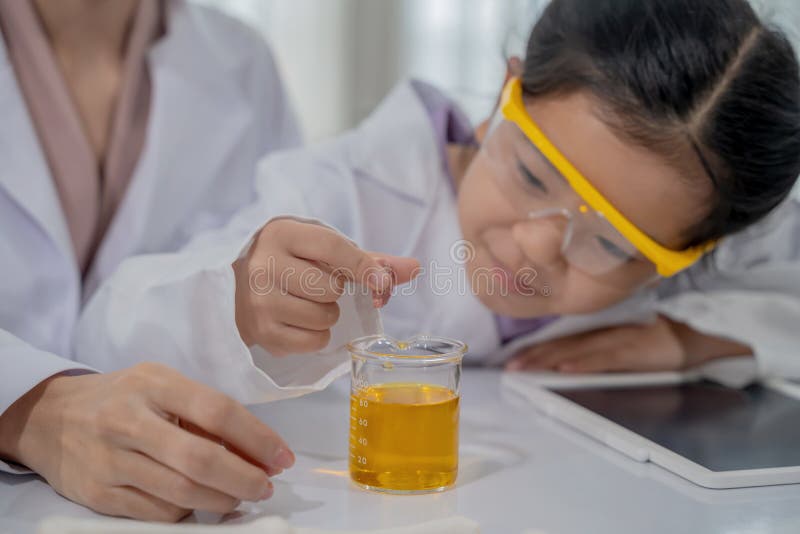 Asian Kid Learning with Scientist in the Laboratory. Physical ...