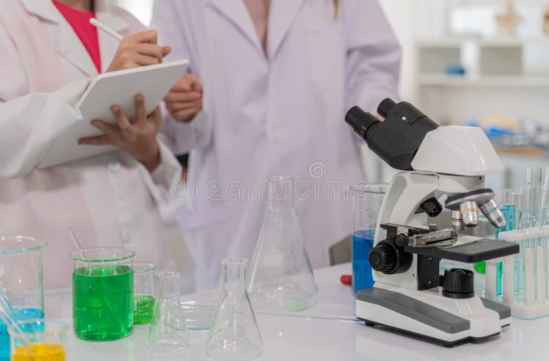 Asian Kid Learning with Scientist in the Laboratory. Physical ...