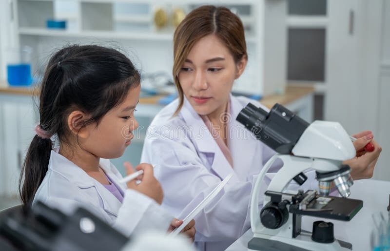 Asian Kid Learning with Scientist in the Laboratory. Physical ...