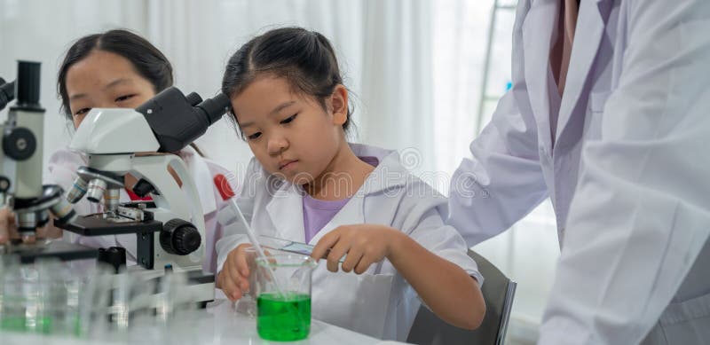 Asian Kid Learning with Scientist in the Laboratory. Physical ...
