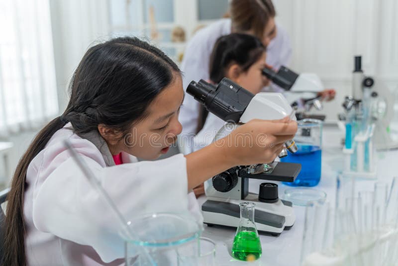 Asian Kid Learning with Scientist in the Laboratory. Physical ...
