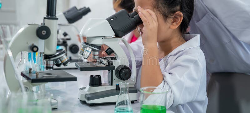 Asian Kid Learning with Scientist in the Laboratory. Physical ...