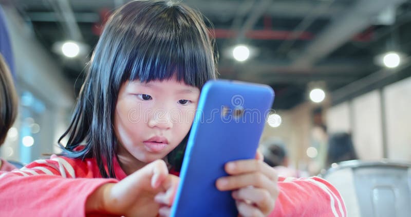 Asian kid play cell phone stock image. Image of chinese - 184426547