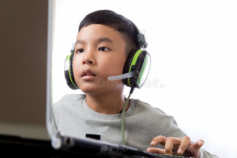 Asian Kid Play Computer Games with Yelling Face Stock Photo - Image of ...