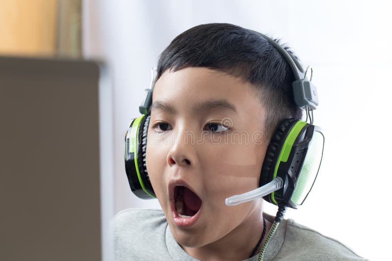 Asian Kid Play Computer Games with Surprising Face Stock Photo - Image ...