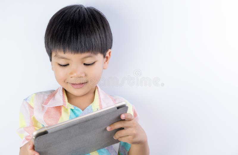 Asian Kid Is Playing Education Game On Tablet On White Stock Image ...