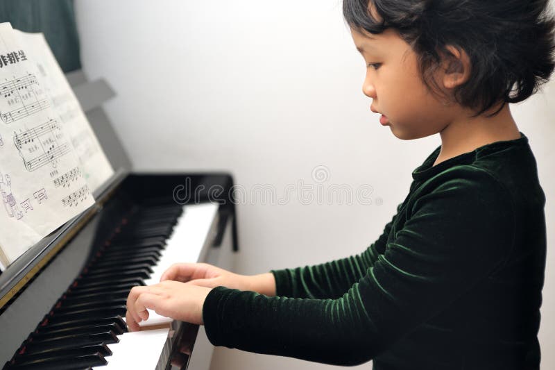 Asian kid playing piano stock photo. Image of cute, instrument - 12073462