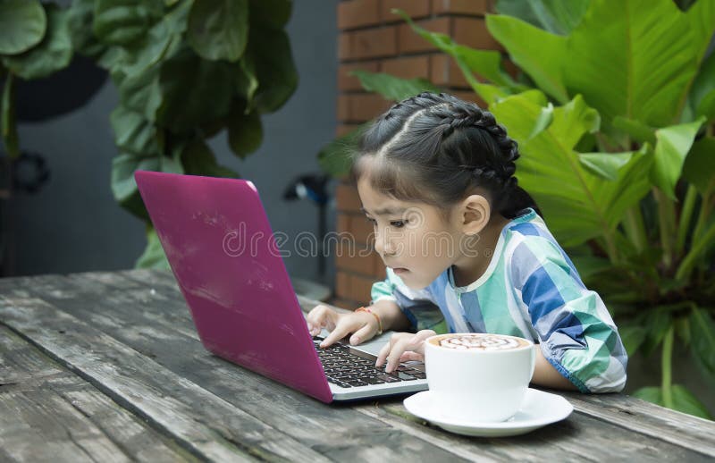 Asian Kids Using Laptop and Coffee Cup on Wood Table Stock Photo ...