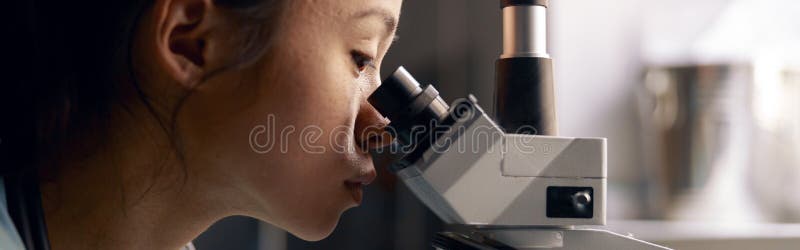 Asian Lab Assistant Uses Microscope Working with Material Sample at ...