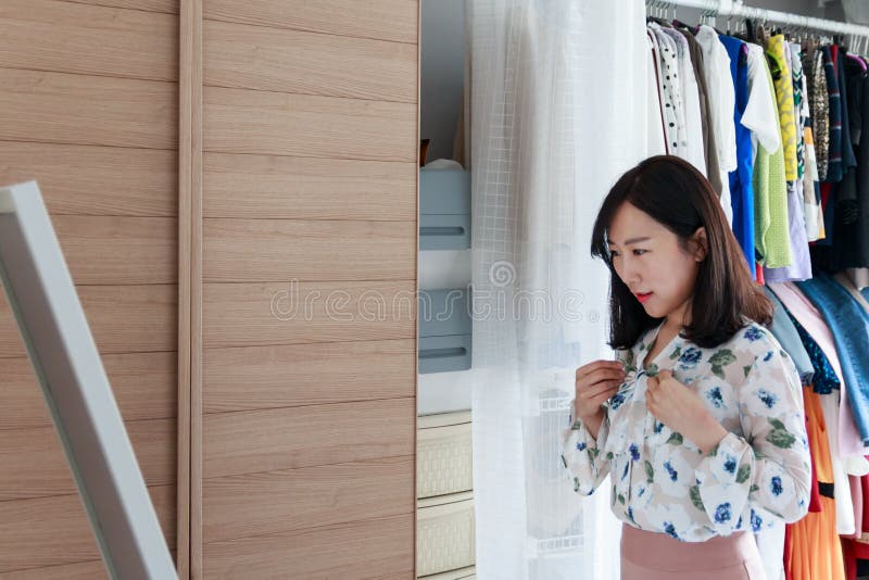 Asian Lady Getting Ready To Go Out in Front of the Mirror Stock Photo ...