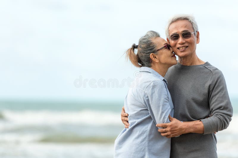 Asian Lifestyle Senior Couple Hug And Kiss On The Beach Happy In Love